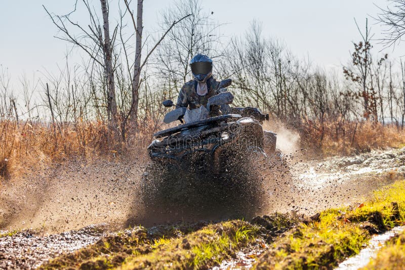 ATV Racer Drives through Mud and Water Stock Photo - Image of ride ...