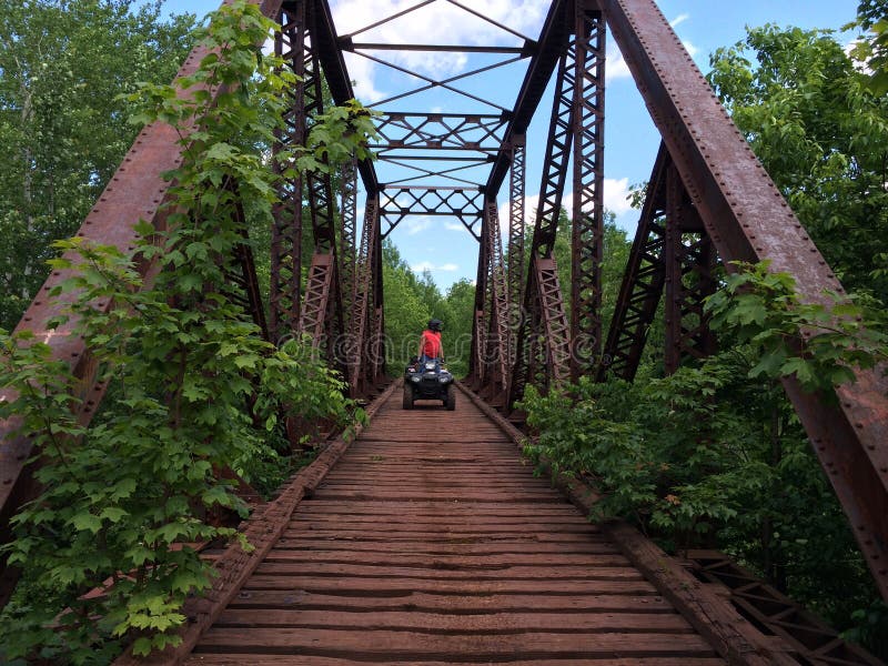 ATV rider on bridge editorial photo. Image of woods, riding - 57590841