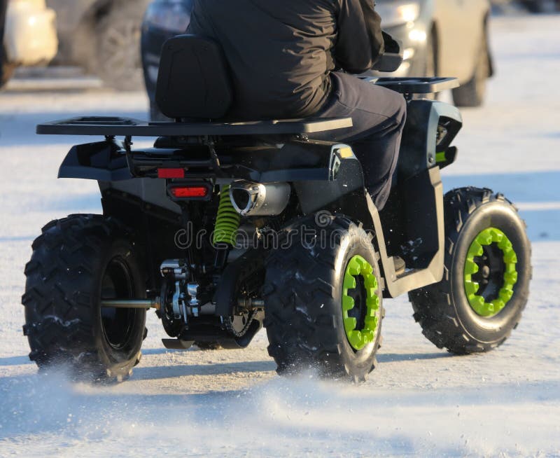 The ATV rides in the snow stock photo. Image of race - 234795932