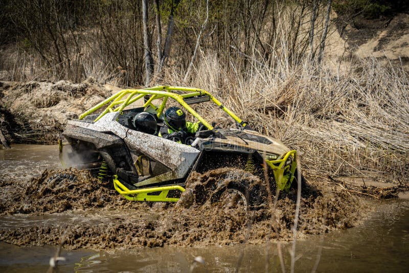 ATV and UTV in Action in Hard Road with Water Mud Splash. Extreme ...