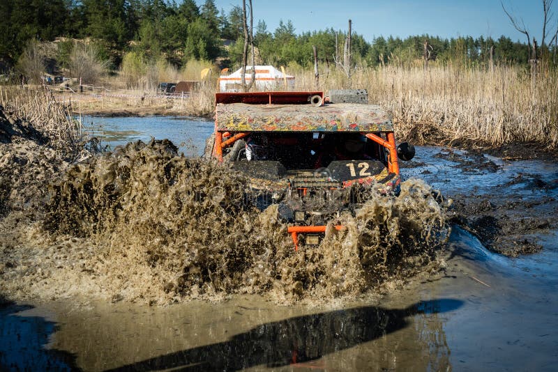 ATV and UTV Riding in Hard Track with Huge Mud Splash. Amateur ...