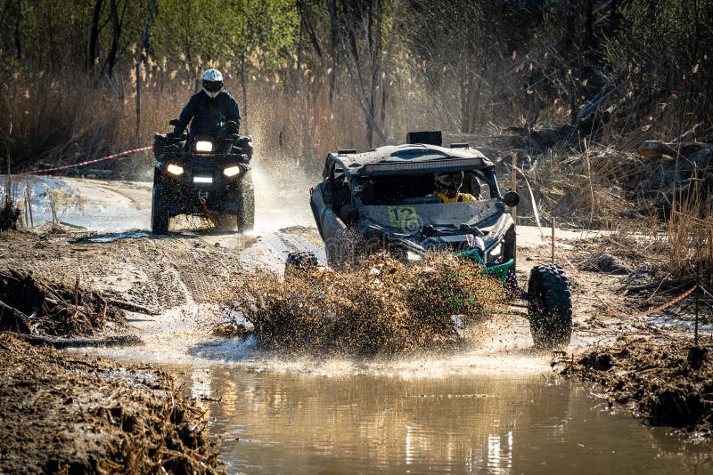 ATV and UTV Riding in Hard Track with Mud Splash. Amateur Competitions ...