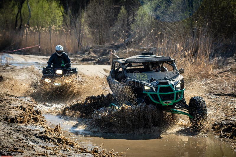 ATV and UTV Riding in Hard Track with Mud Splash. Amateur Competitions ...
