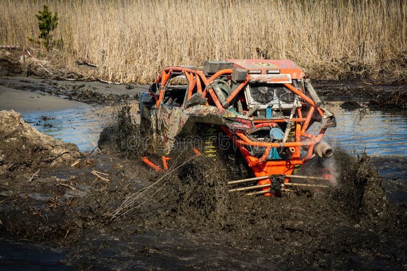 ATV and UTV Riding in Hard Track with Mud Splash. Amateur Competitions ...
