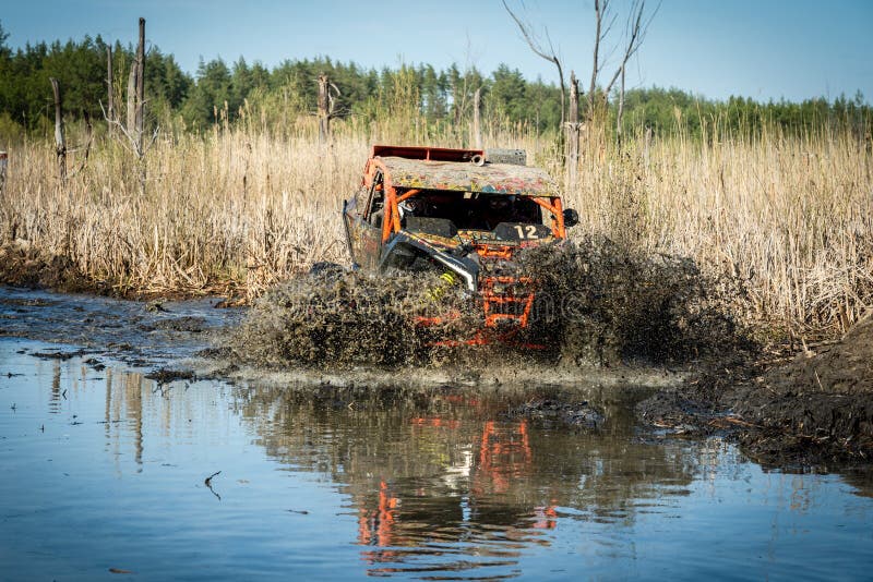 ATV and UTV Riding in Hard Track with Mud Splash. Amateur Competitions ...
