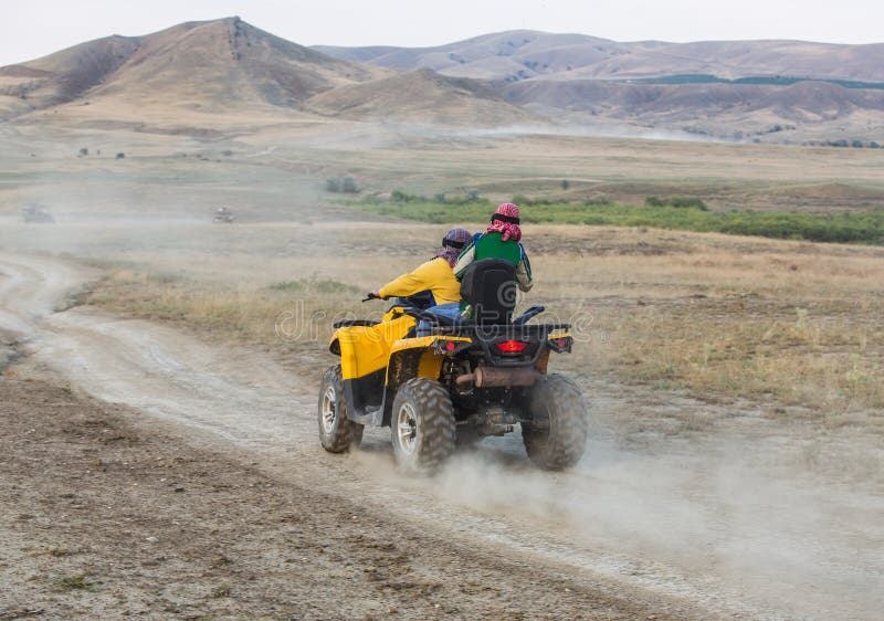 ATVs with People Riding Over Rough Terrain Stock Photo - Image of dirt ...