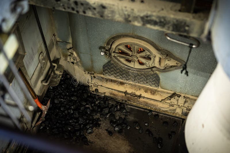 A Worker Insert a Coal Inside the Engine of Coaled Power Steam Ship ...