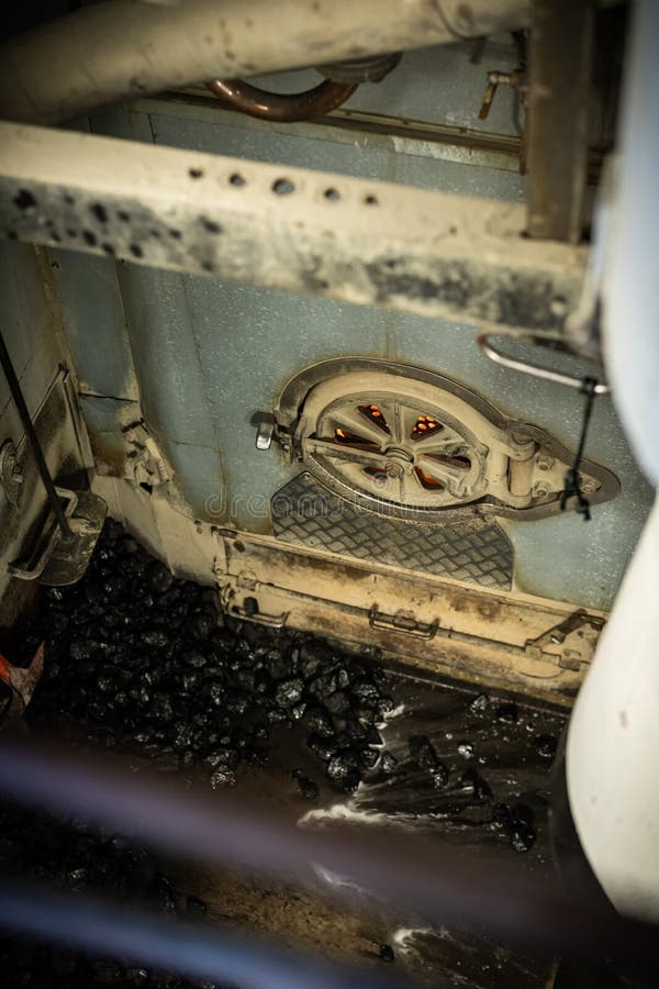 A Worker Insert a Coal Inside the Engine of Coaled Power Steam Ship ...