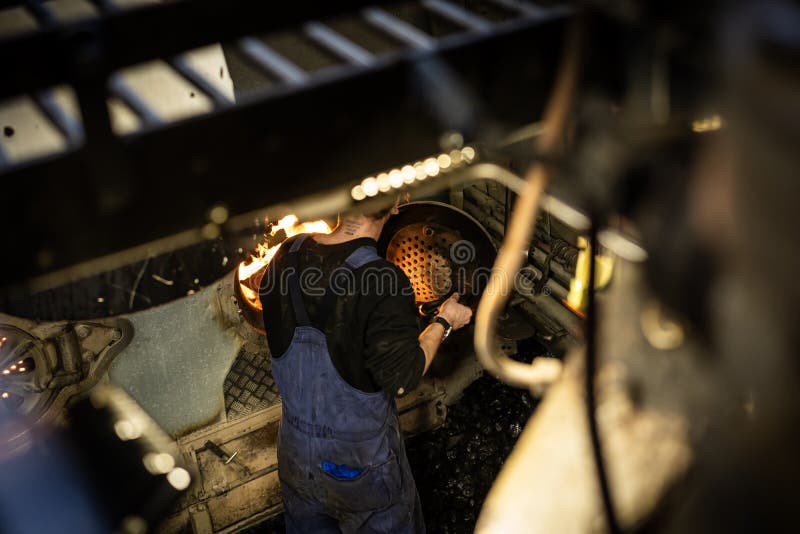 A Worker Insert a Coal Inside the Engine of Coaled Power Steam Ship ...
