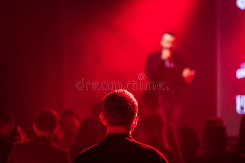 Audience Enjoying Live Performance Under Vibrant Red Stage Lighting ...