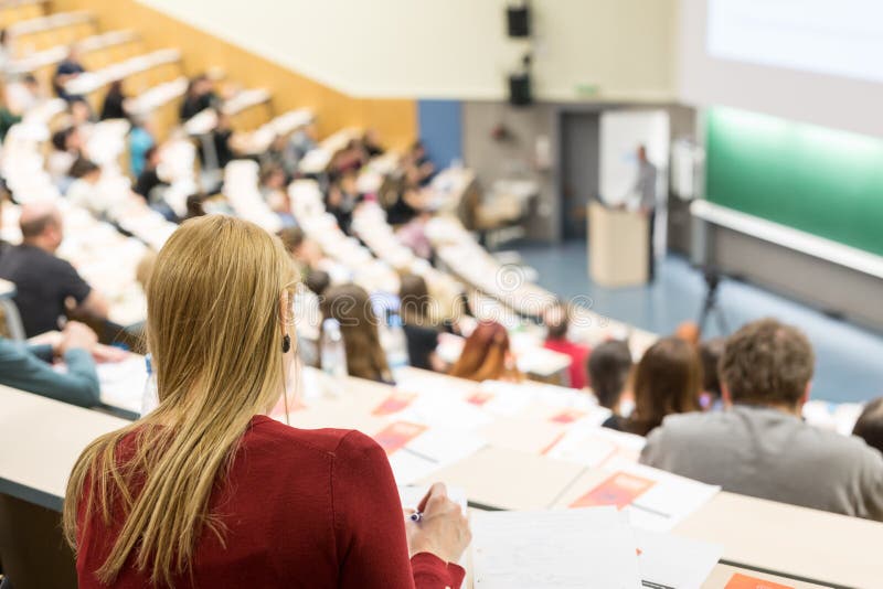 Audience in the Lecture Hall. Female Student Making Notes. Stock Image ...