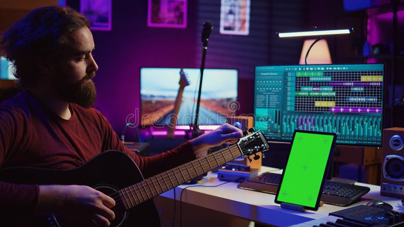 Audio Engineer Practices Tuning His Acoustic Guitar in Home Studio ...