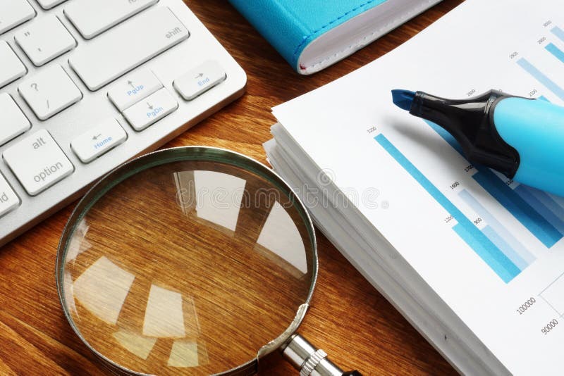 Audit and Assessment. Magnifying Glass and Stack of Business Papers ...