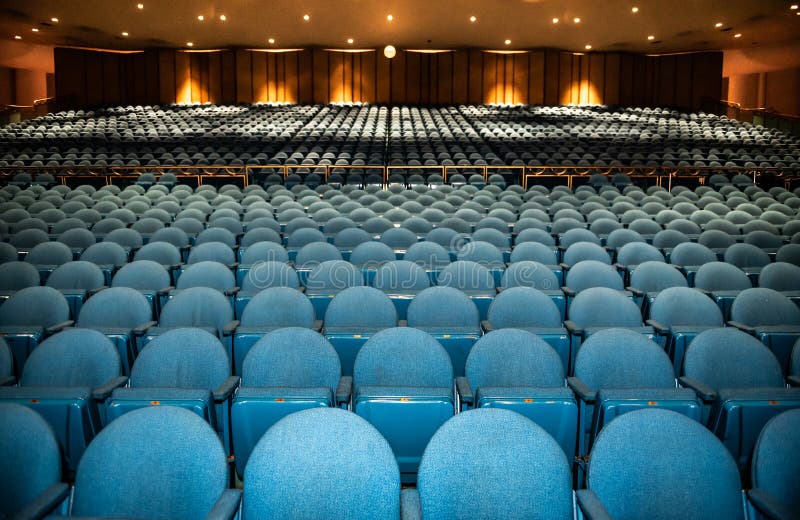 Auditorium with Rows of Blue Seats with Railing in Back Stock Image ...