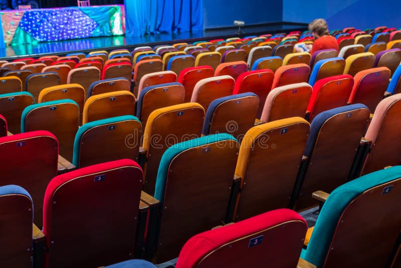 The Auditorium in the Theater. Multicolored Spectator Chairs Stock ... The Auditorium in the Theater. Multicolored Spectator Chairs Stock ...