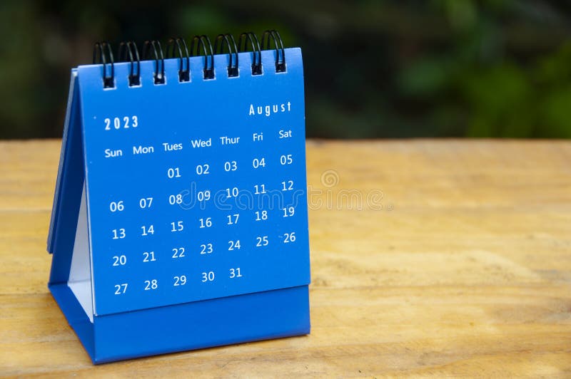 August 2023 Blue Desk Calendar on Wooden Table Background with ...