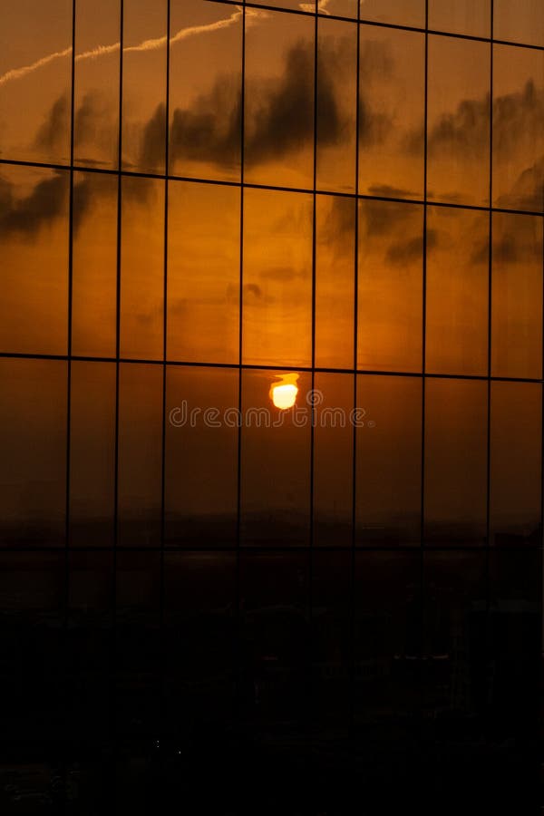 Dramatic Sunrise Reflected in the Windows of a Skyscraper in the ...
