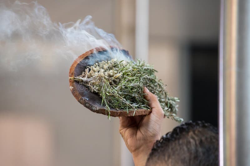 Australian Aboriginal Ceremony, Man Hand with Green Branches and Flame ... Australian Aboriginal Ceremony, Man Hand with Green Branches and Flame ...