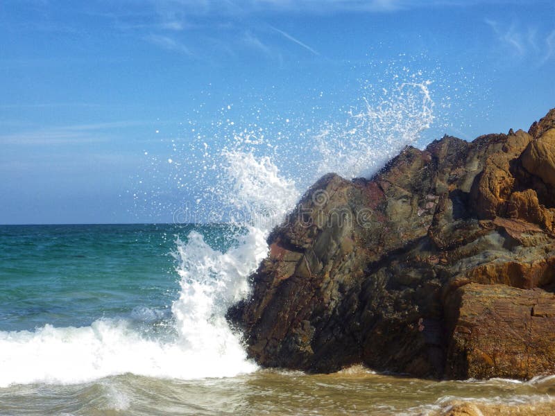 Wave crashing over rock stock image. Image of wave, scene - 115419807
