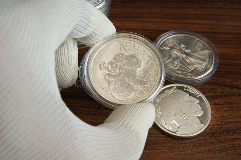 An Australian Silver Coin in the Hand of a Numismatist. Pure Silver ...