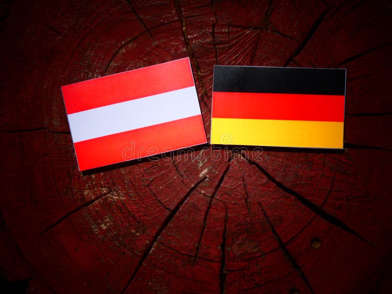 Austrian Flag with German Flag on a Tree Stump Stock Image - Image of ...