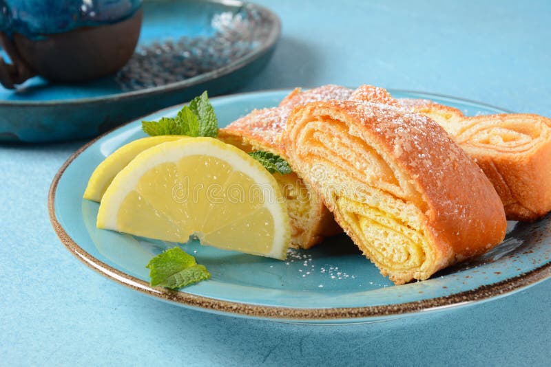 Austrian Strudel with Lemon and Mint and with Powdered Sugar on a Plate ...