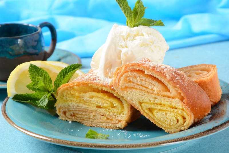 Austrian Strudel with Lemon and Mint and with Powdered Sugar on a Plate ...