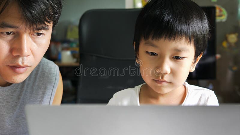 Authentic Asian Child Boy Using Laptop with Father. Kid Looking To ... Authentic Asian Child Boy Using Laptop with Father. Kid Looking To ...