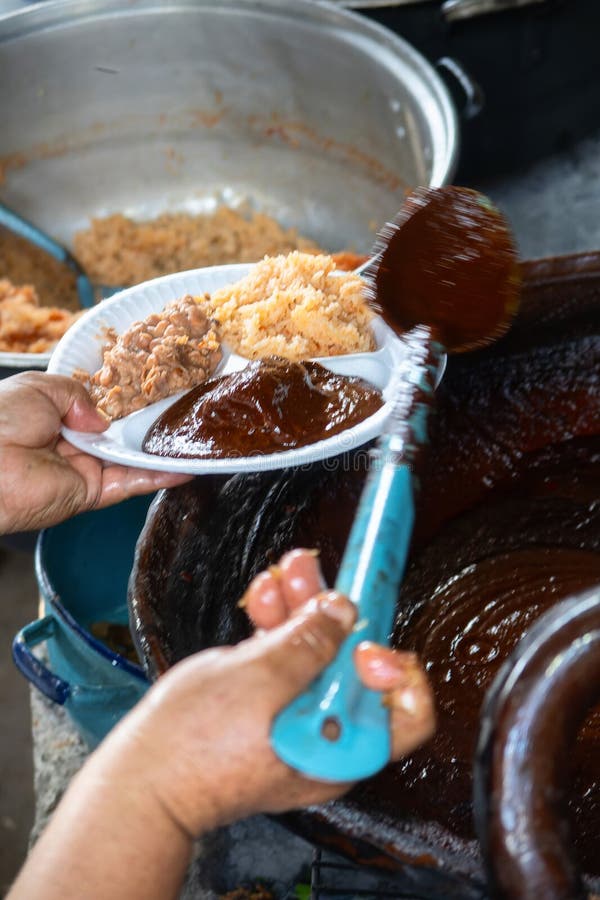 Authentic Mexican Mole Rojo Served with Rice and Refried Beans in ...