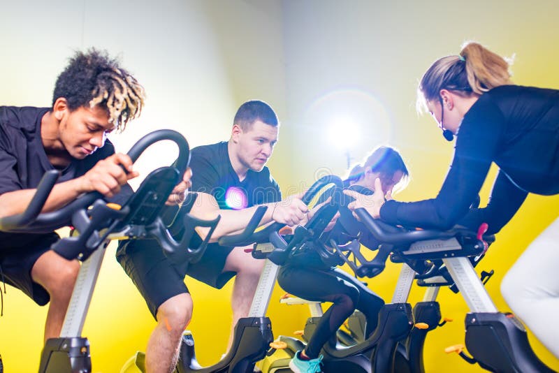 Authentic Mixed Race Group Training on Exercise Bikes Teamwork Stock ...