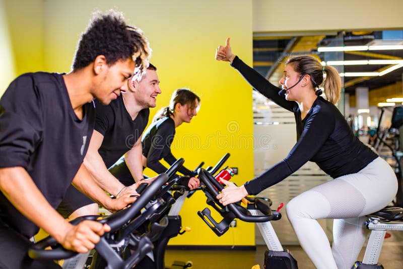 Authentic Mixed Race Group Training on Exercise Bikes Teamwork Stock ...