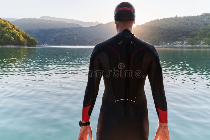 Authentic Triathlon Athlete Getting Ready for Swimming Training on Lake ...
