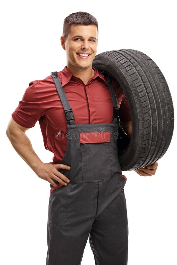 Auto Mechanic Carrying a Tire and Smiling at the Camera Stock Photo ...