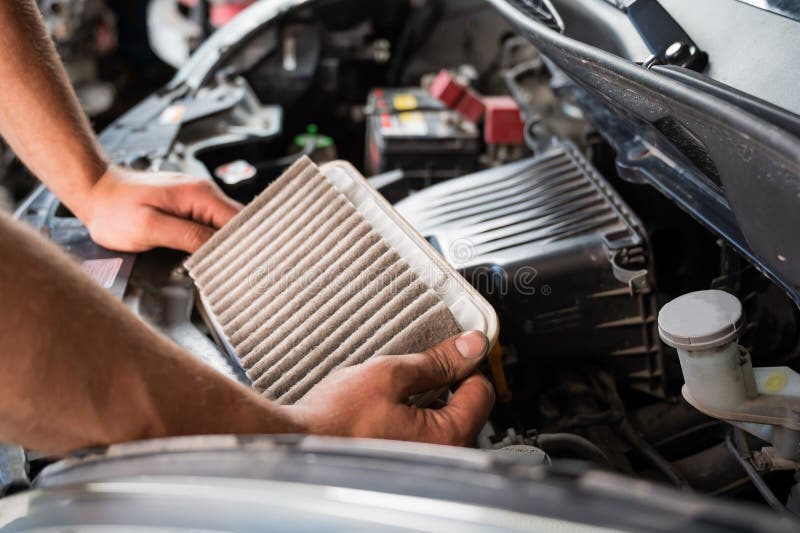 An Auto Mechanic is Changing the Air Filter in the Car Stock Photo ...