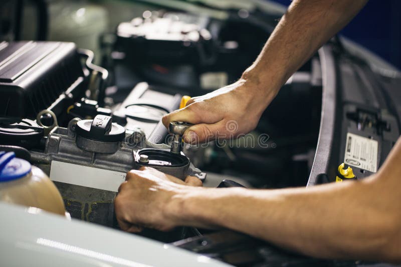 Auto Mechanic is Changing Motor Oil into a Engine Stock Image - Image ...