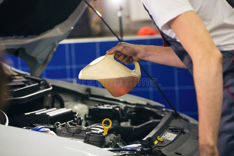 Auto Mechanic is Changing Motor Oil into a Engine Stock Image - Image ...