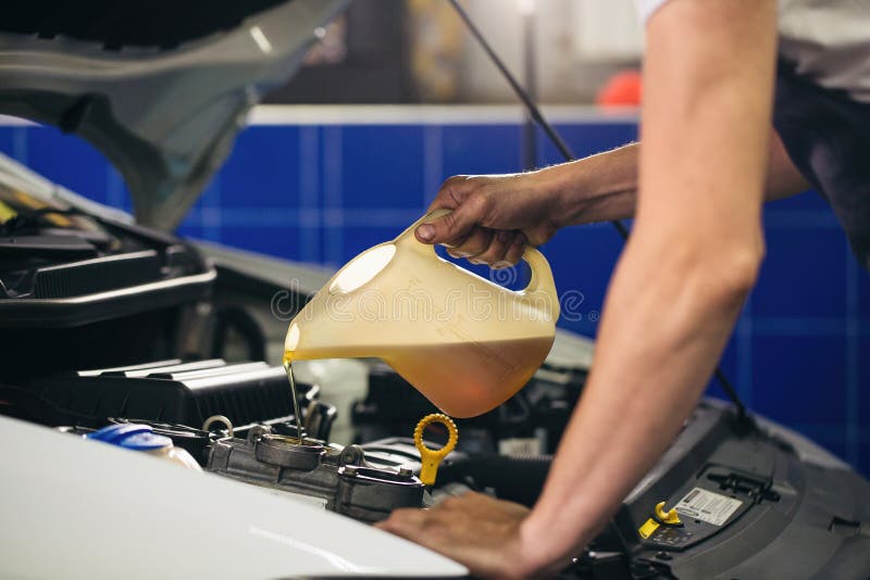 Auto Mechanic is Changing Motor Oil into a Engine Stock Image - Image ...