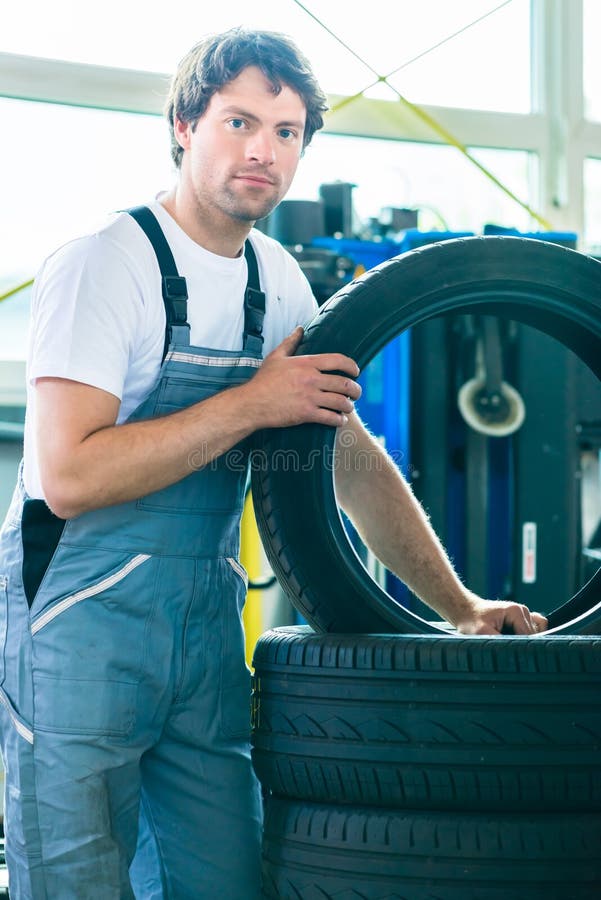 Auto Mechanic Changing Tire in Workshop Stock Image - Image of ...