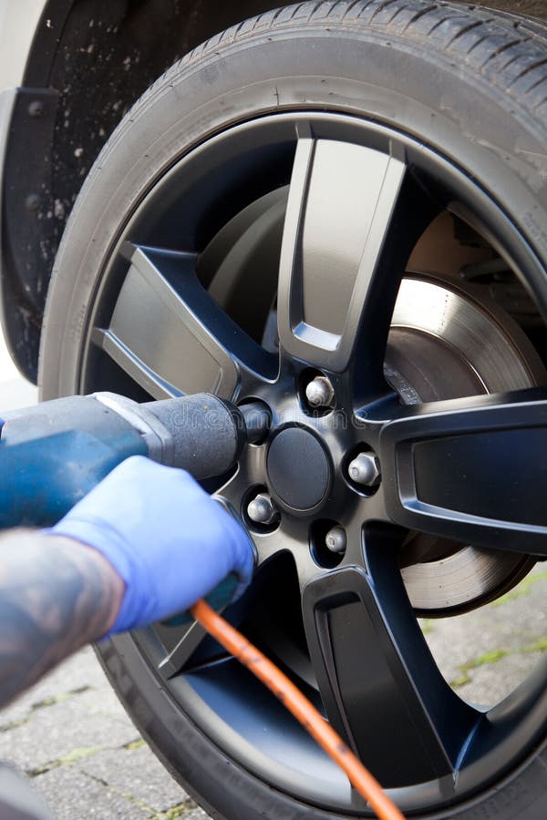 Auto Mechanic Changing Wheel on Car with Pneumatic Wrench. Stock Image ...