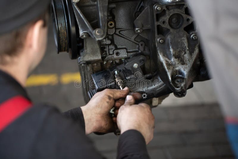 Auto Mechanic Checking an Internal Combustion Engine Stock Photo ...
