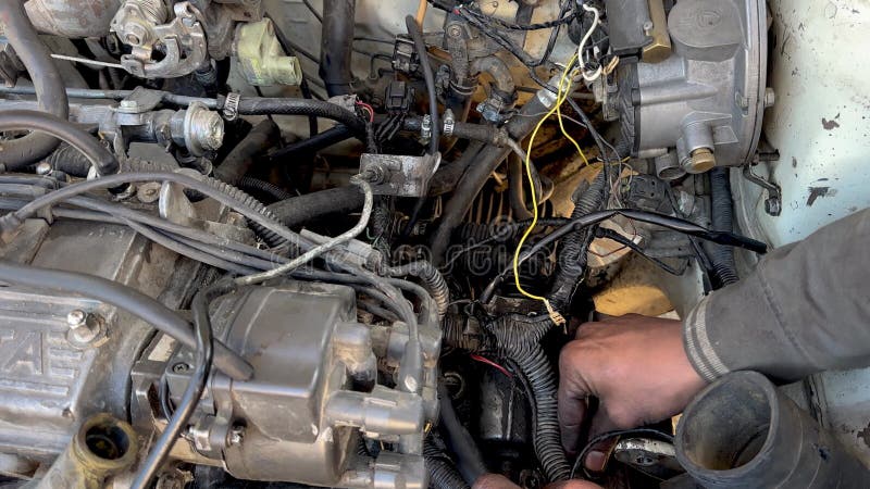 Auto Mechanic Doing Car Service and Maintenance Work on an Old Engine ...
