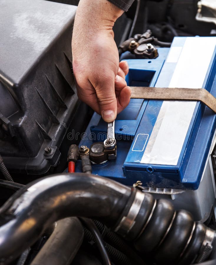 Fitting a battery to a car stock photo. Image of repair - 54665070