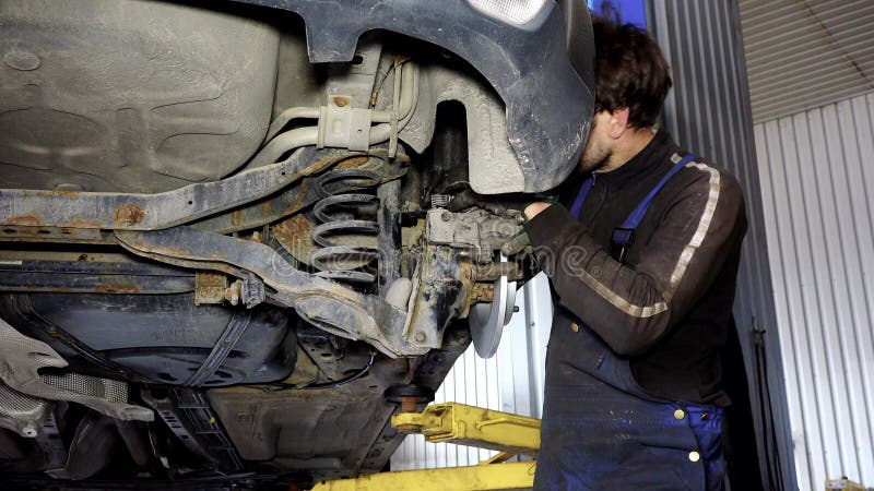 Auto Mechanic Guy Working on Car Brake System. Stock Footage - Video of ...