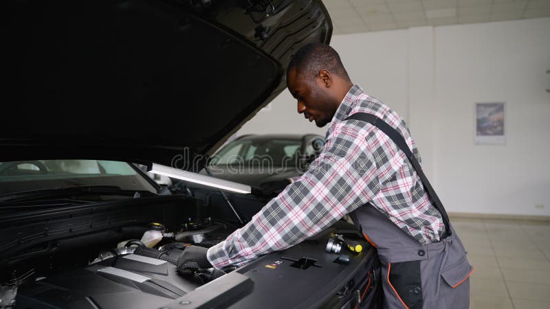 Auto Mechanic Inspecting Car Engine with Work Lamp Stock Footage ...