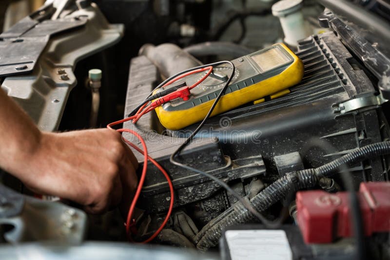 Auto Mechanic Measures Voltage with Multimeter. Stock Photo - Image of ...