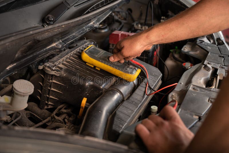 Auto Mechanic Measures Voltage with Multimeter. Stock Photo - Image of ...