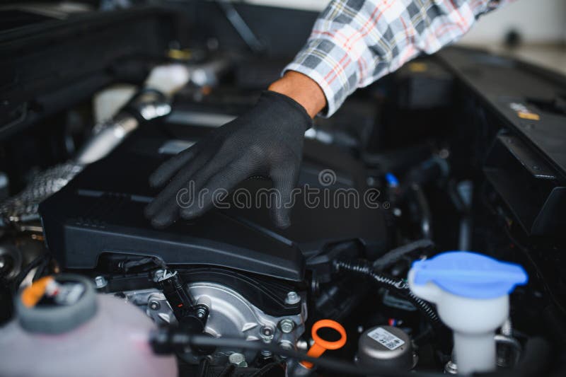 Auto Mechanic Performing a Routine Service Inspection in a Service ...