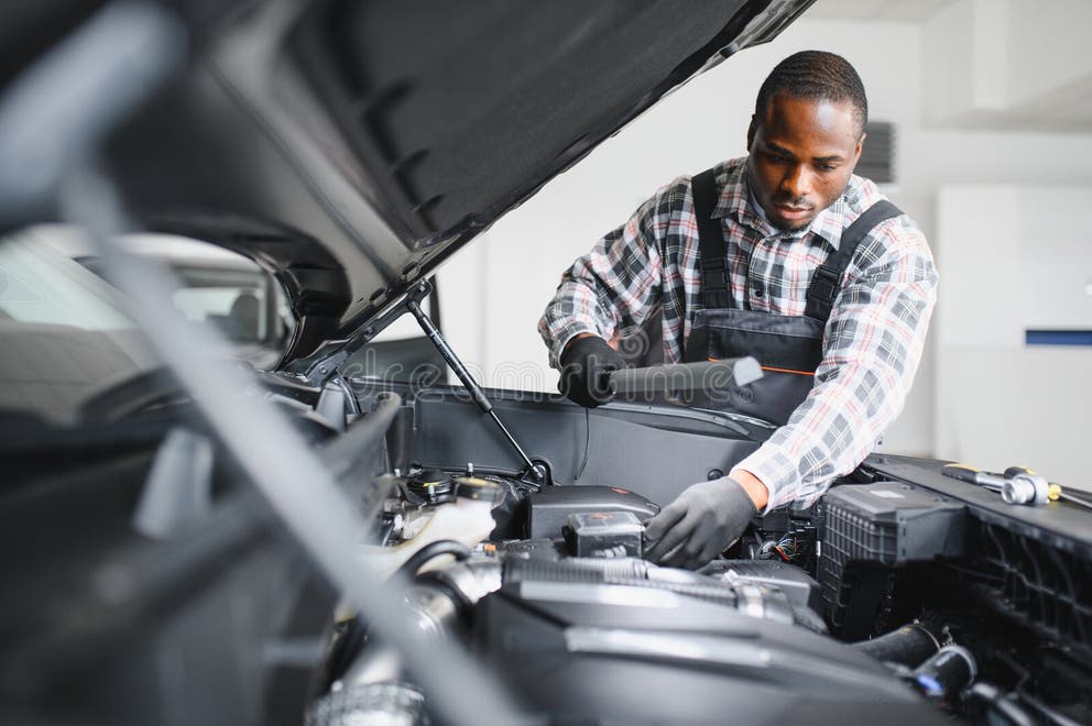 Auto Mechanic Performing a Routine Service Inspection in a Service ...
