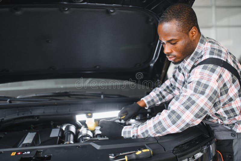 Auto Mechanic Performing a Routine Service Inspection in a Service ...