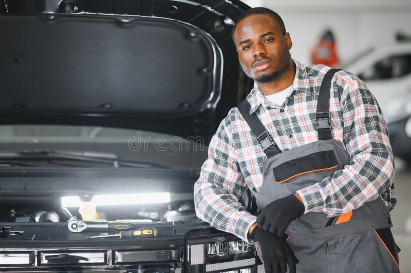 Auto Mechanic Performing a Routine Service Inspection in a Service ...